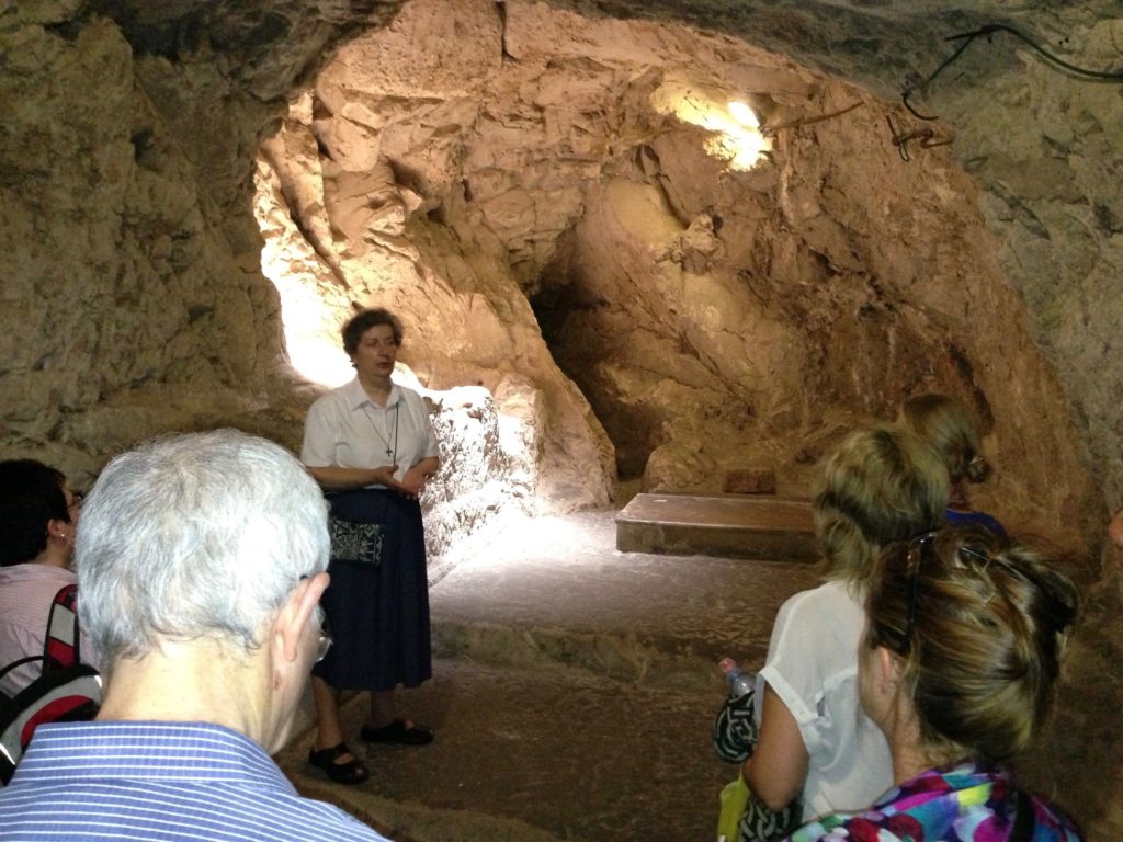 Sr Stefania talking to visitors in the cave church (© Gregory Jenks ...